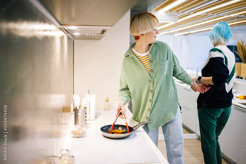 Female paying attention to her wife during cooking Stock Photo | Adobe ...
