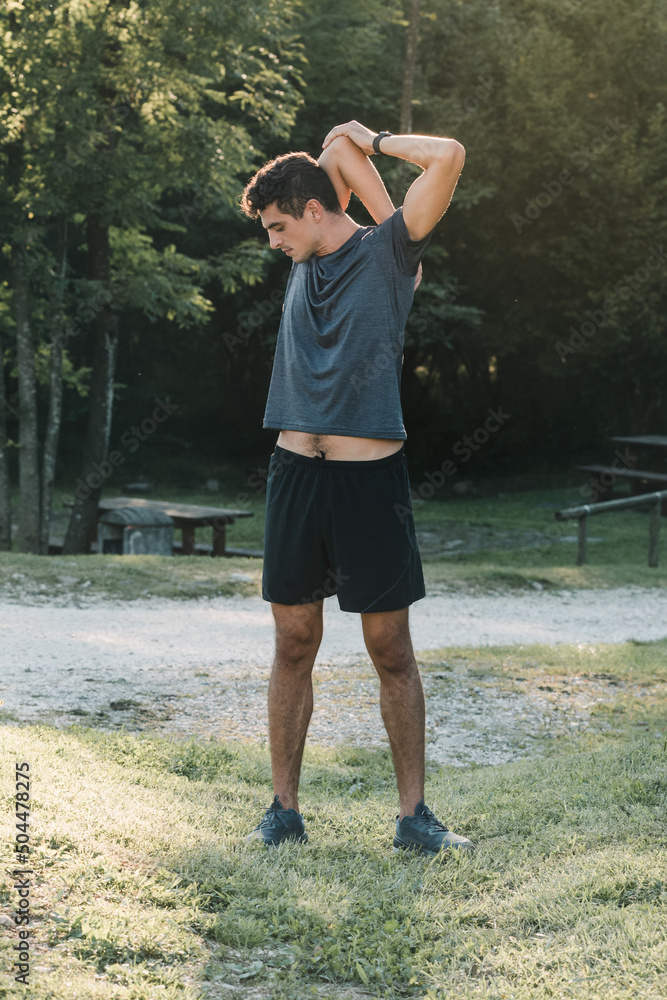 Young Boy Stretching in the Woods Stock Photo | Adobe Stock