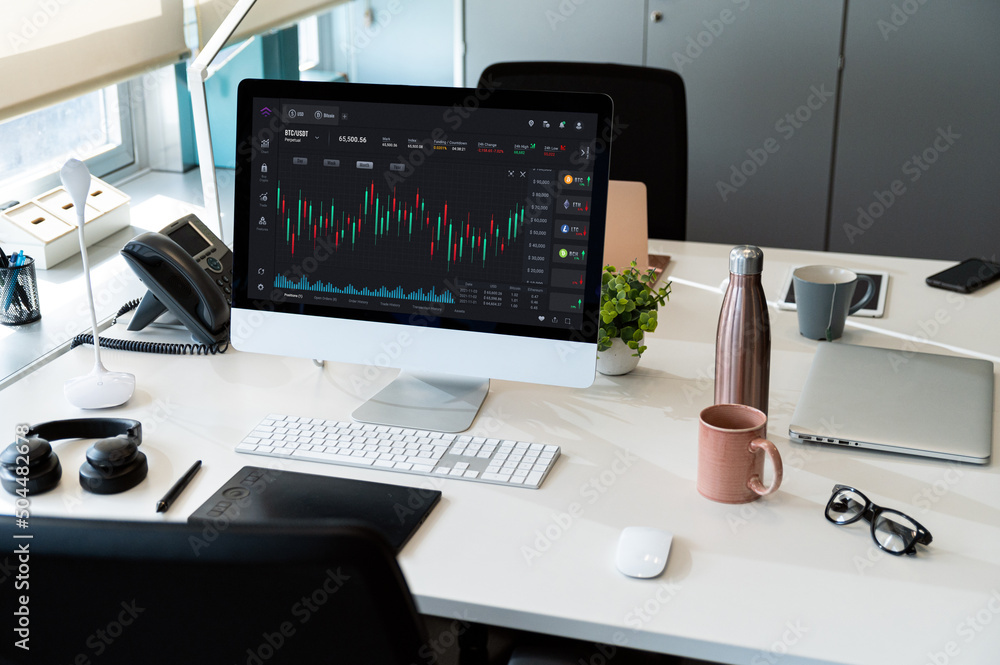 Workplace with computer placed on table with chart Stock Photo | Adobe ...