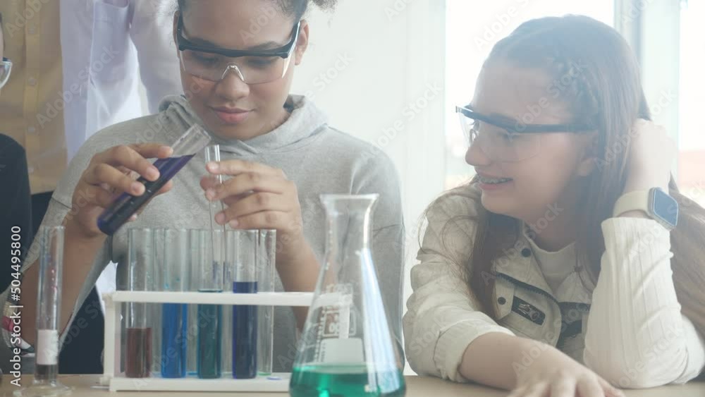 Young teacher teaching group student about science and explaining ...