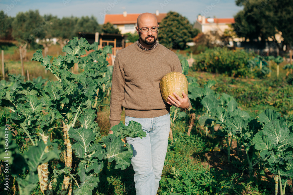 Man carrying harvest Stock Photo | Adobe Stock