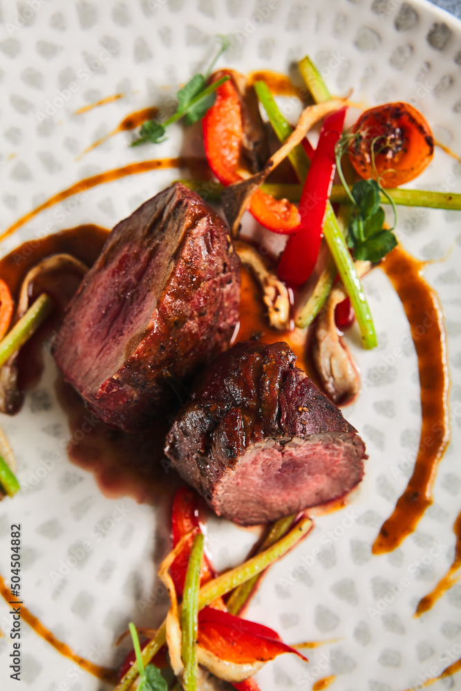 Roasted Beef fillet with vegetables. Roasted Mignon steak with paprika ...