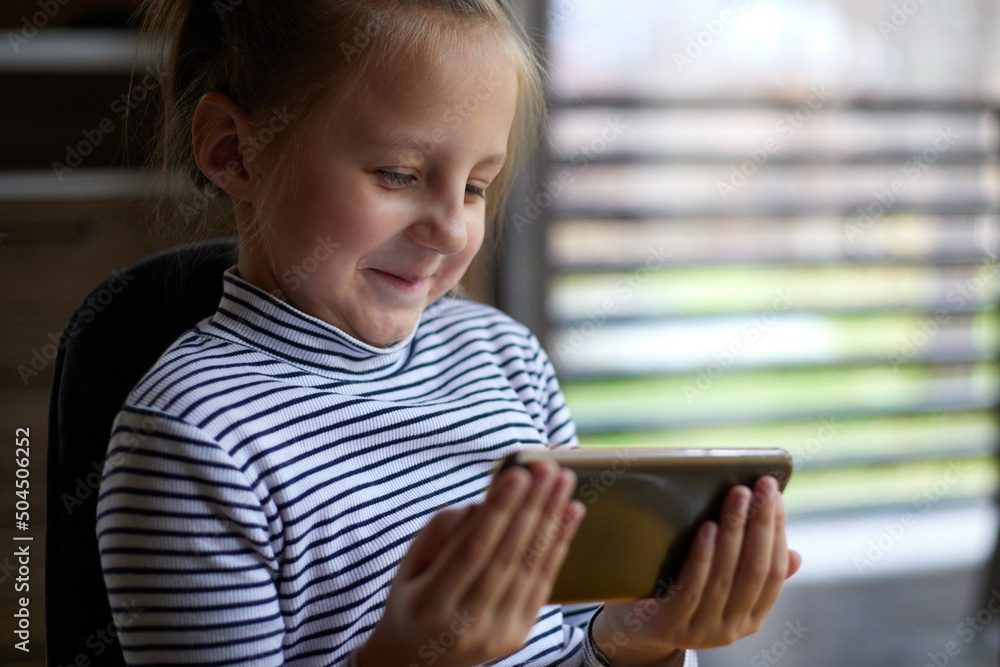 Portrait of a child with a smartphone Stock Photo | Adobe Stock