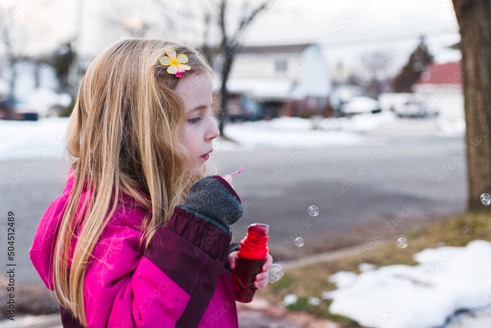 Little girl blowing bubbles Stock Photo | Adobe Stock