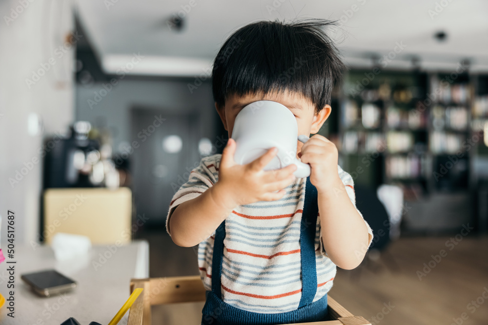 Little boy drinking from a cup Stock Photo | Adobe Stock