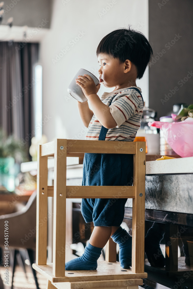 Little boy drinking from a cup Stock Photo | Adobe Stock