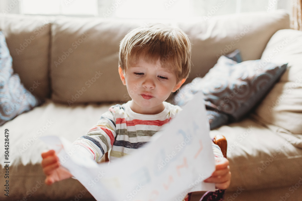 Little boy looking at drawing Stock Photo | Adobe Stock