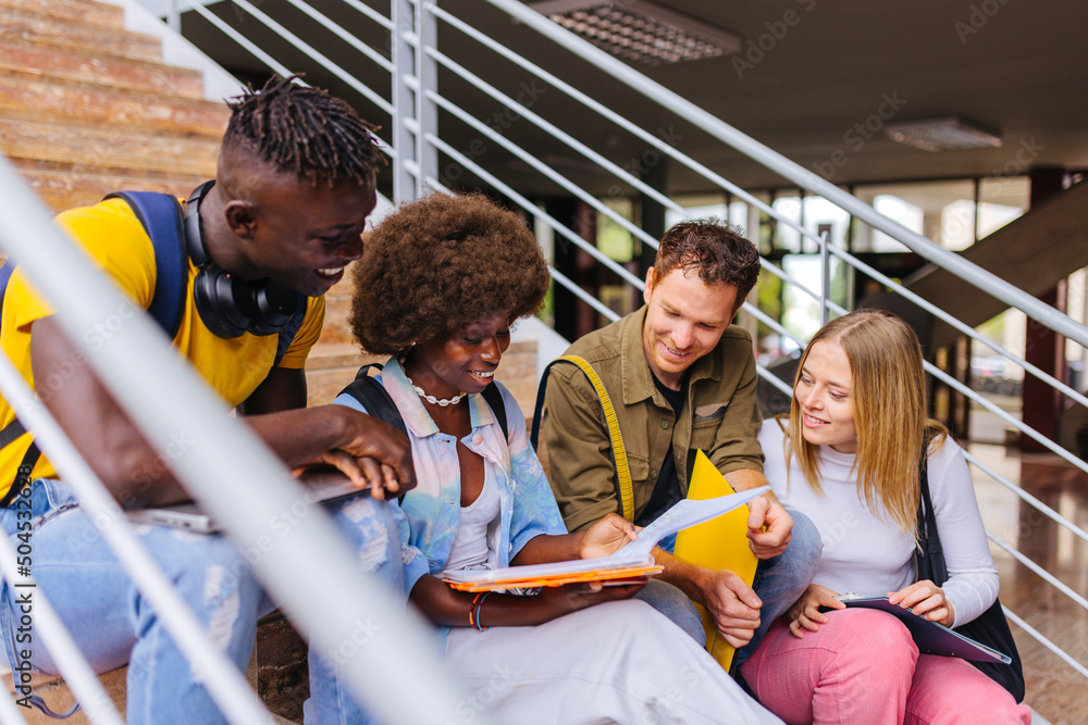 Multiethnic students with textbooks at university Stock Photo | Adobe Stock