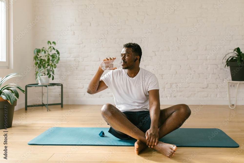 Athlete male drinking water from the bottle indoors Stock Photo | Adobe ...