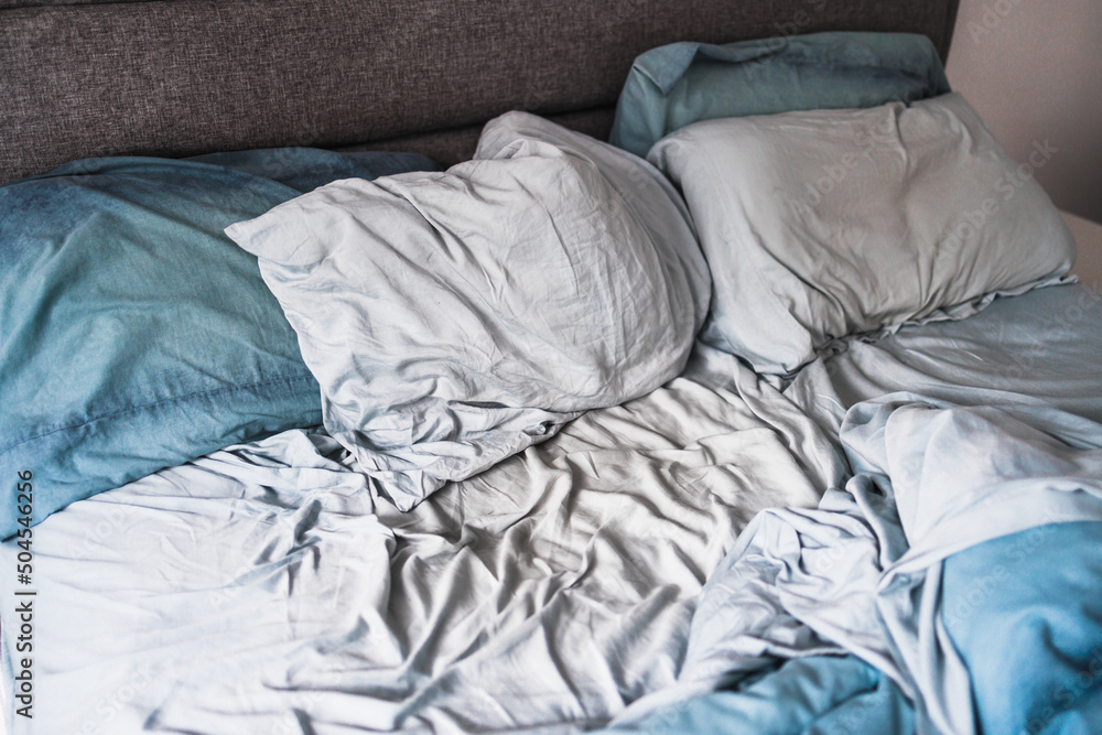 improving your sleep or couple life, messy bed with blue quilt cover ...