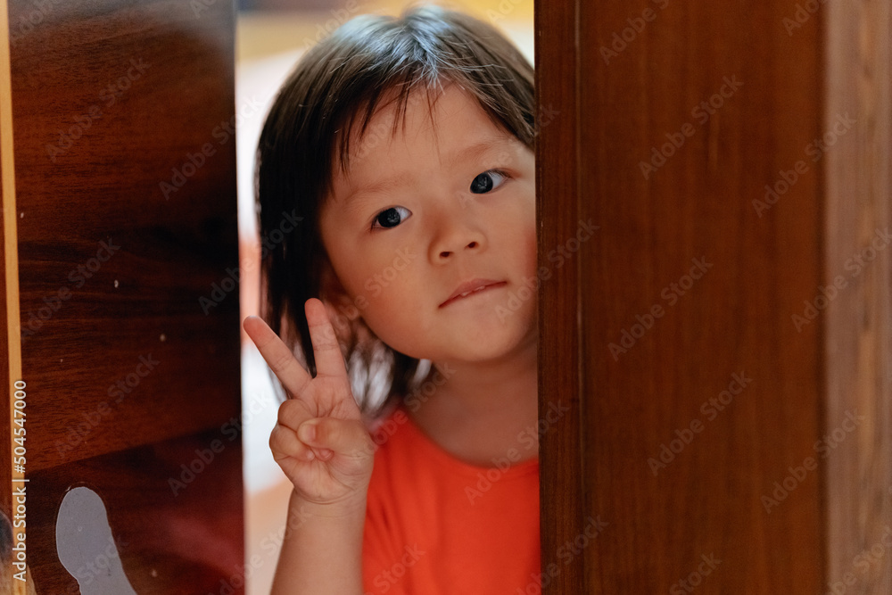 Cute little girl opens the door Stock Photo | Adobe Stock