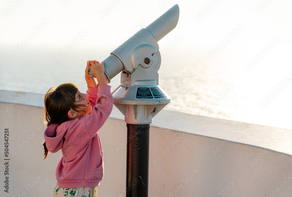 Little girl looking with monocular Stock Photo | Adobe Stock