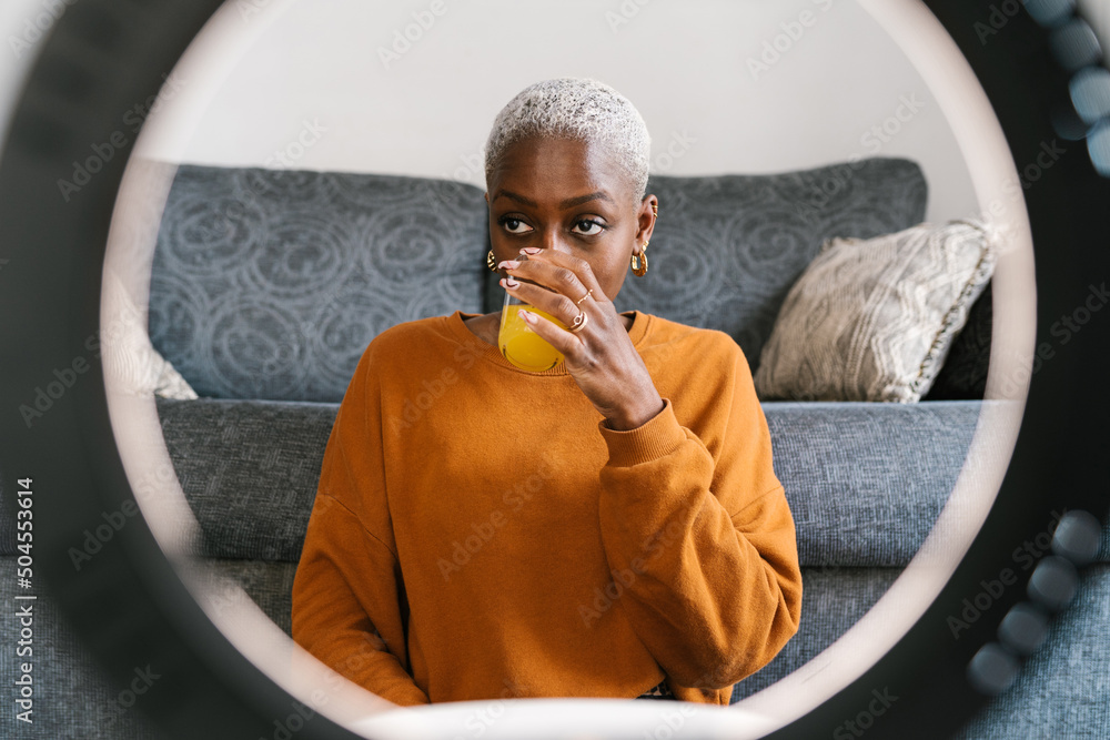 Model drinking orange juice at home Stock Photo | Adobe Stock