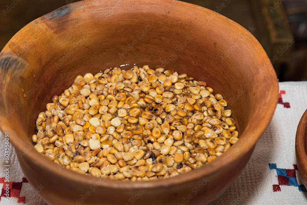 Roasted yellow corn kernels soaking in water inside a clay pot Stock ...