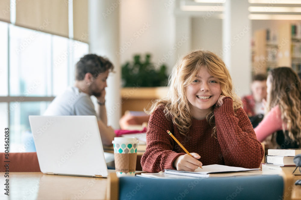 Smiling College Student At Library Table Stock Photo | Adobe Stock