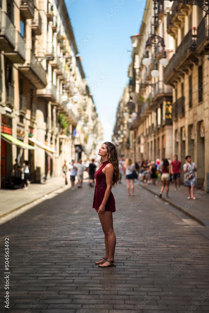 Beautiful woman exploring city streets Stock Photo | Adobe Stock