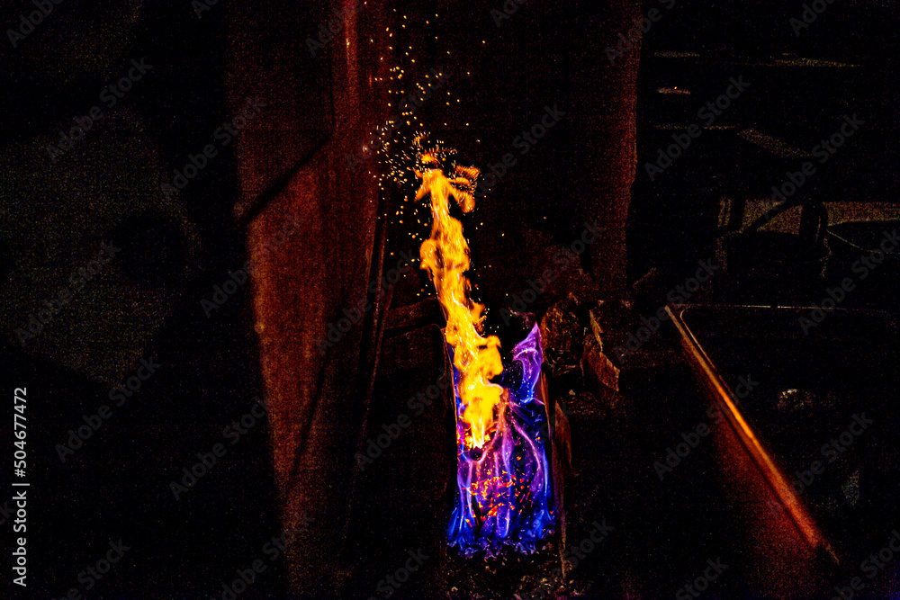 Fire and coal forging Japanese sword in a kiln of a blacksmith in Japan ...