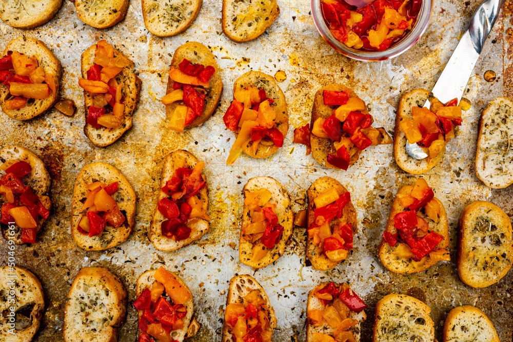bruschetta mini toasts spread with oily gourmet red, yellow, and orange ...