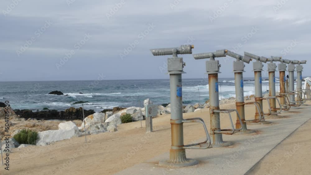 Stationary binoculars, telescope, tower viewer or scope, ocean waves on ...