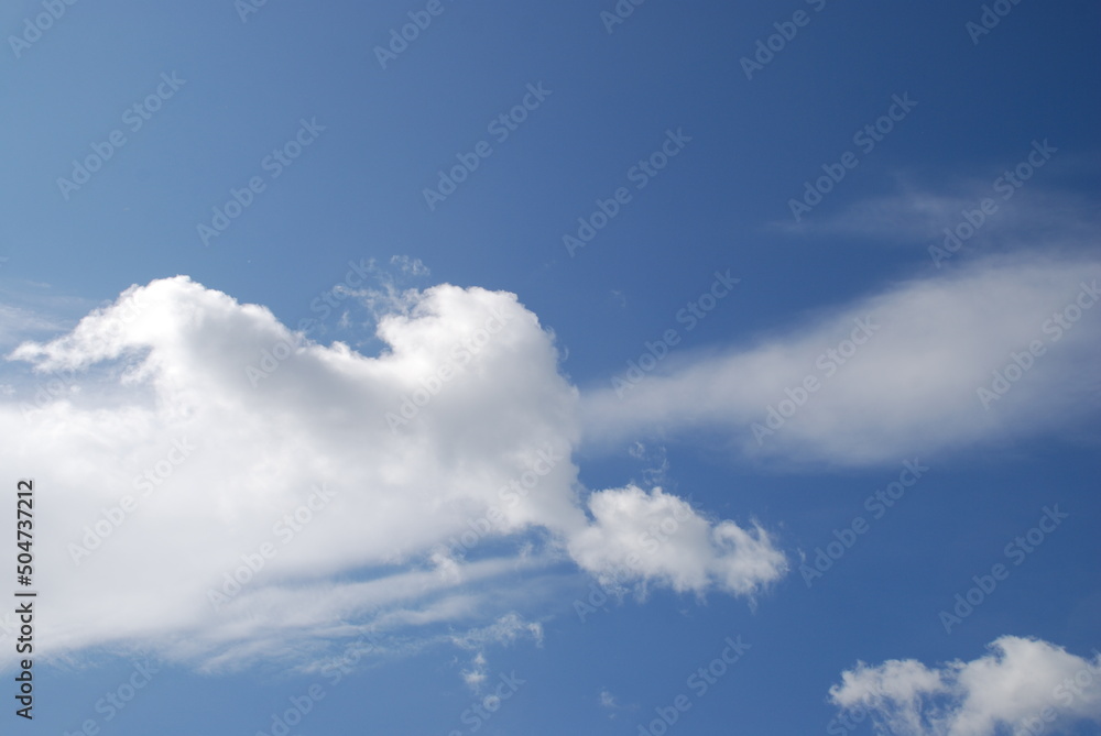 Layered clouds against the sky. Multilevel white clouds are floating in ...