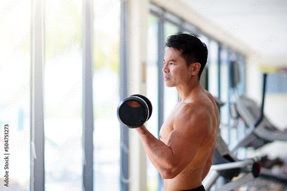Man exercising in gym. Bodybuilder lifting weights Stock Photo | Adobe ...