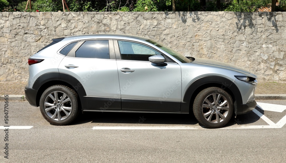Udine, Italy. May 13, 2022. Silver gray Mazda CX30 on stonewall wall ...