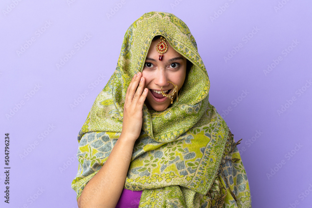 Indian woman isolated on purple background with surprise and shocked ...