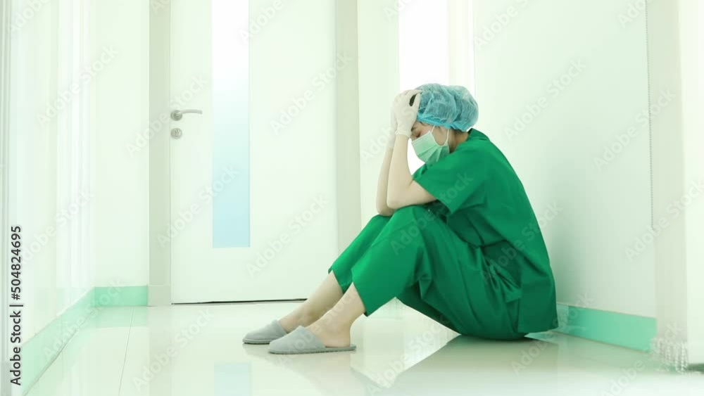 Female surgeon treating stressed and anxious patient sitting in front ...