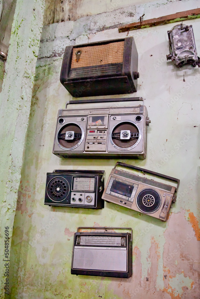 A collection of old radios and tape recorders. Retro outdated portable ...