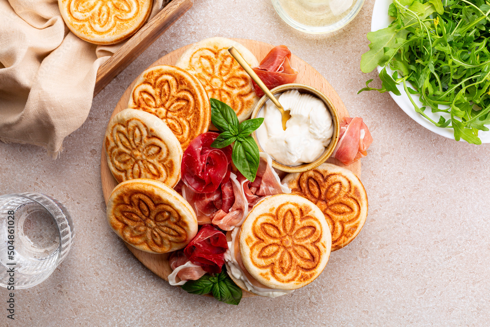 Italian aperitivo or aperitif with Tigelle, prosciutto, italian ham ...