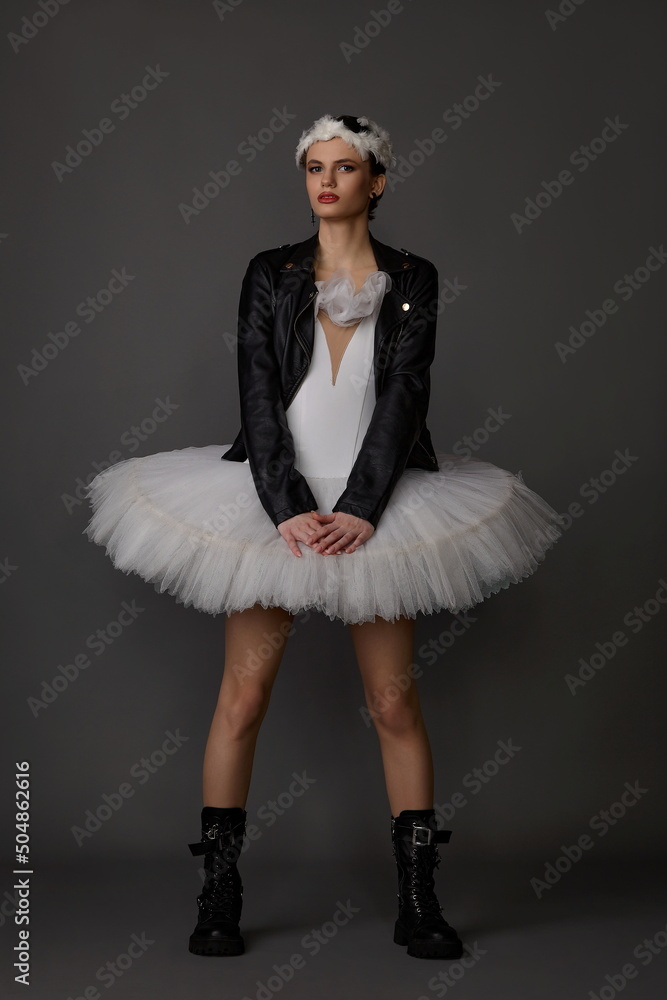 Beautiful girl ballerina in a white tutu, leather jacket and large army ...