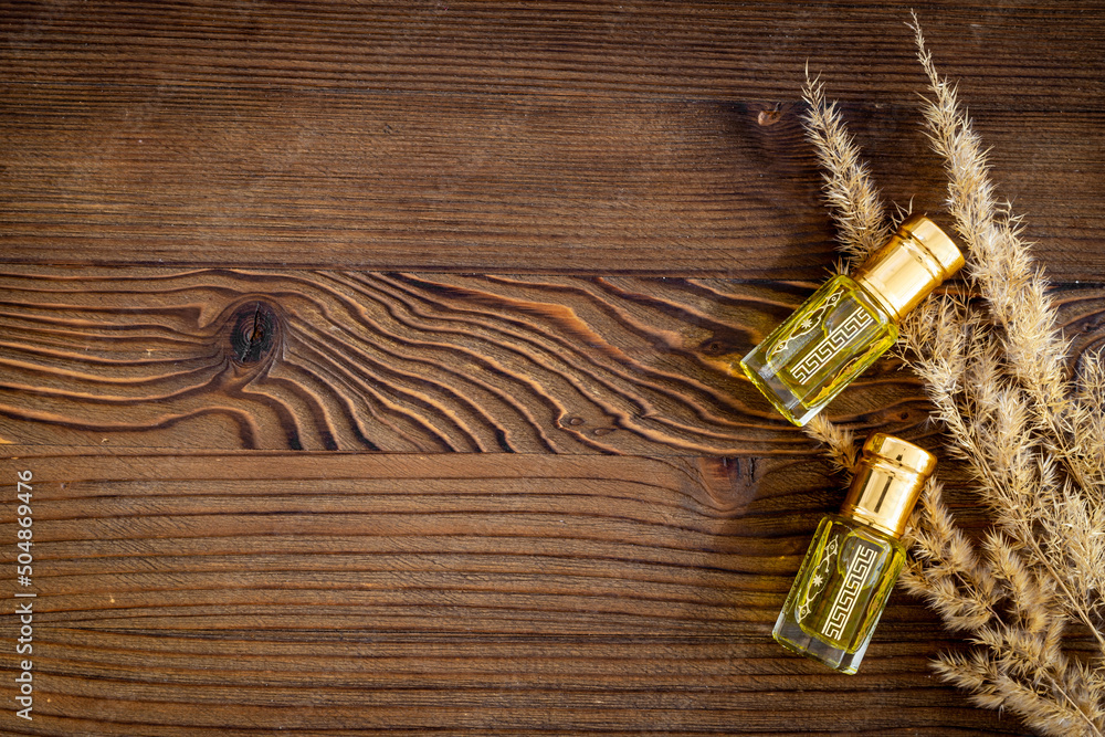 Perfume essential oil in glass bottles, top view. Traditional Arabian ...