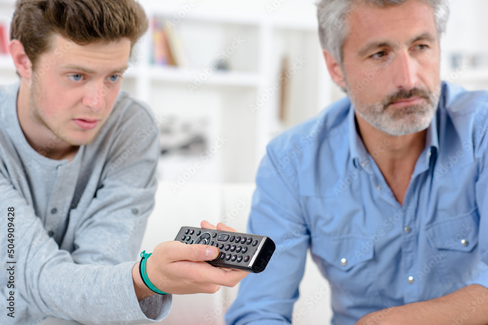 men with a remote control Stock Photo | Adobe Stock