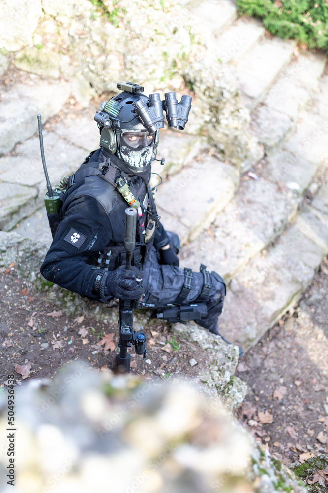 cosplayer military man armed with submachine gun with silencer and ...