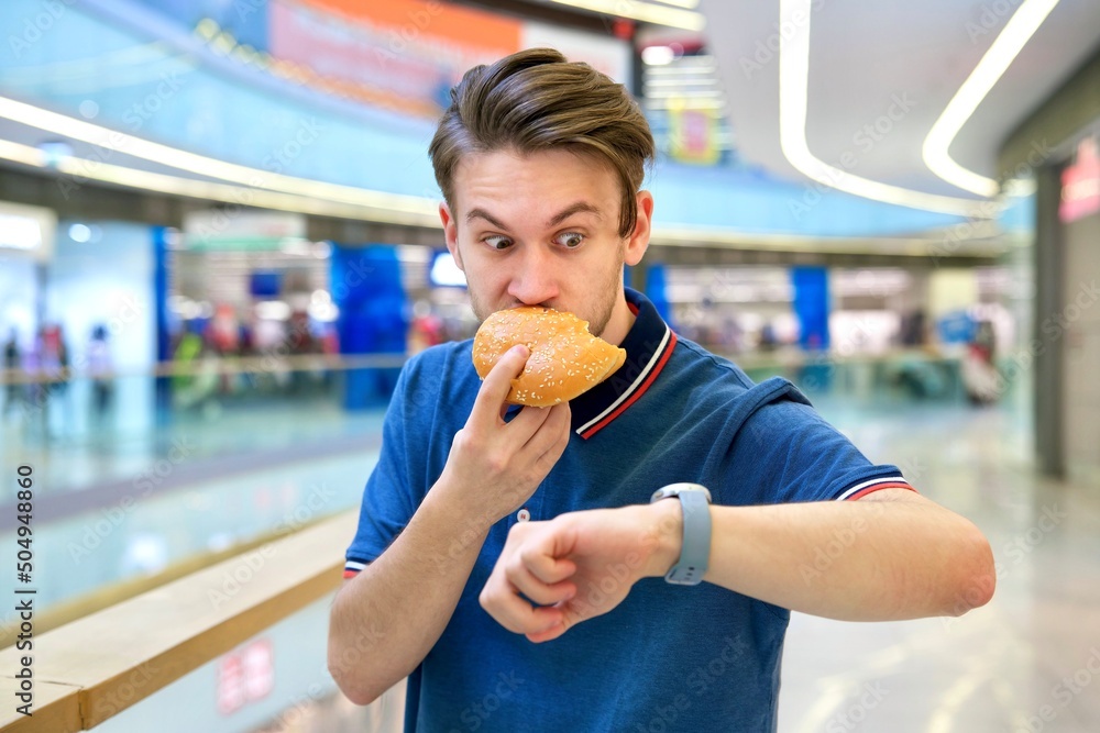 Nervous stressed hungry guy, man in hurry, rush biting, eating big ...