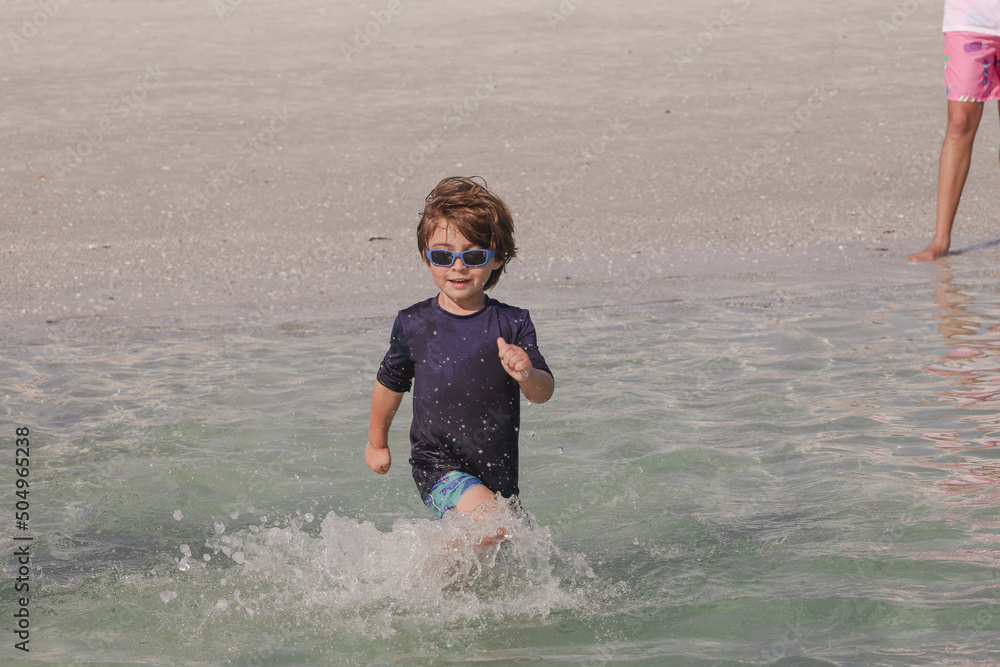 boy playing on Sunset Beach located at the southern tip of Treasure ...