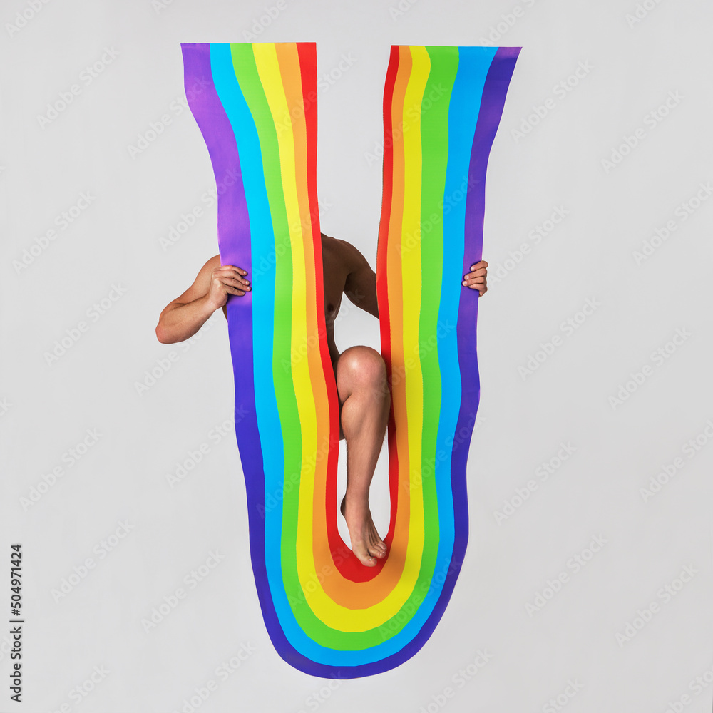 a muscular man comes in the upside down arch with rainbow pattern ...