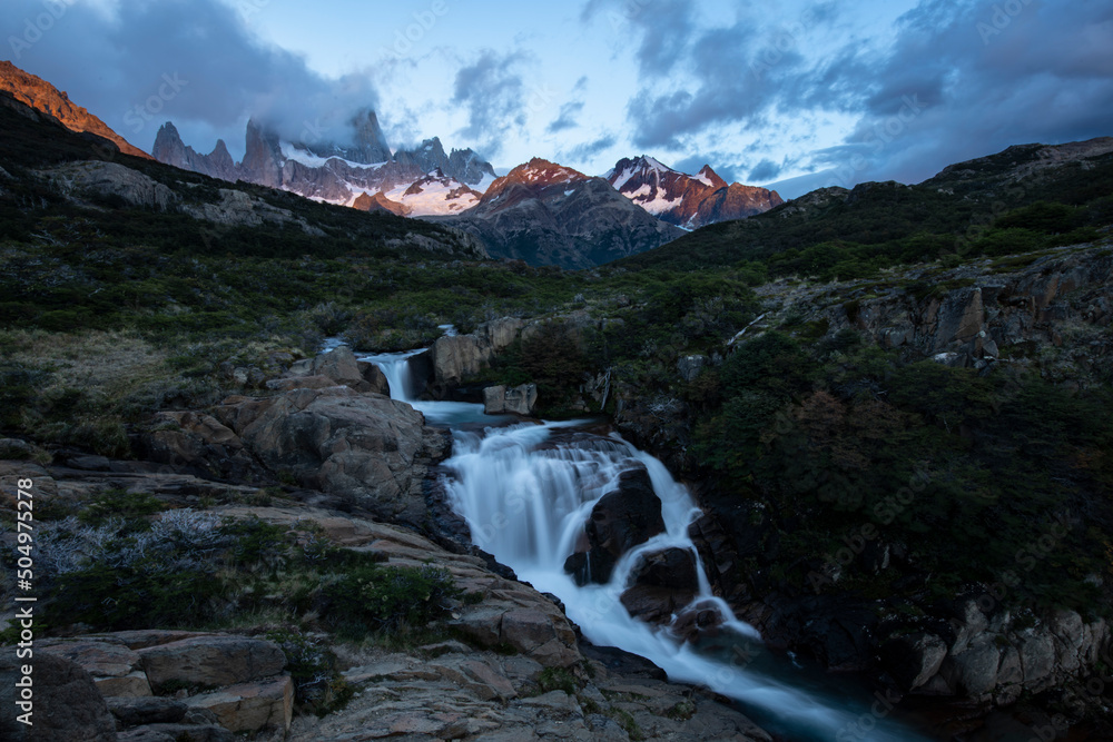 A big waterfall cascades before the Fitzroy massif, the iconic p Stock Photo | Adobe Stock