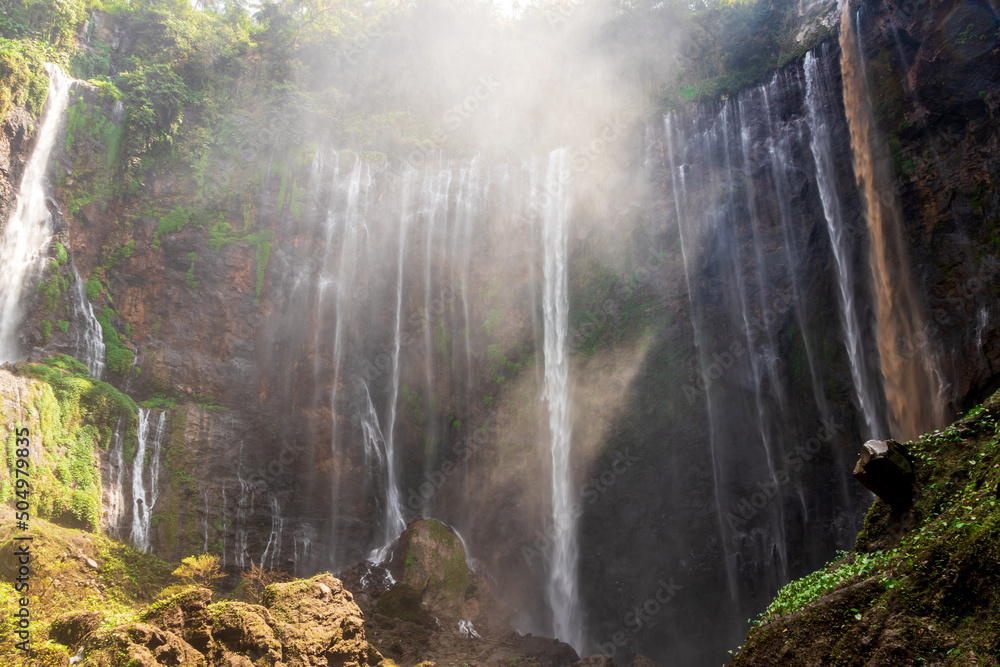 Waterfall streams from the whole half circle cliff from the bottom of ...