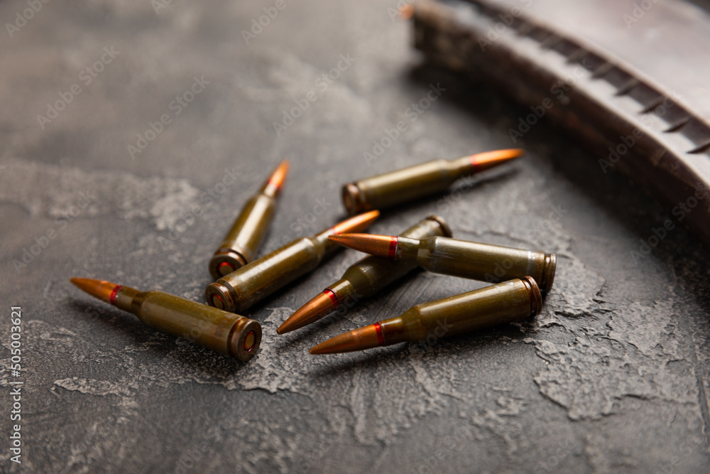 Bullets on black textured marble. Bullets of a kolashnikov assault ...