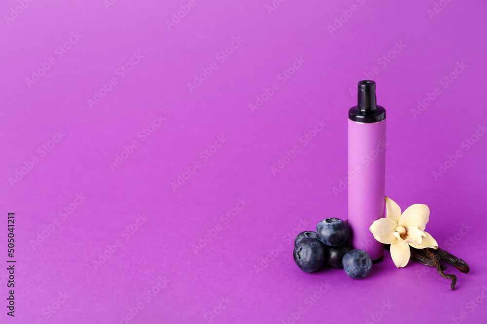 Disposable electronic cigarette, blueberries and vanilla flower on ...