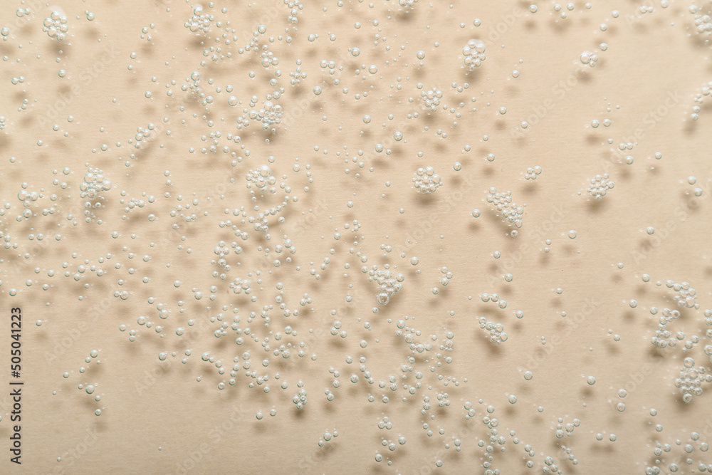 Water with bubbles on beige background Stock Photo | Adobe Stock