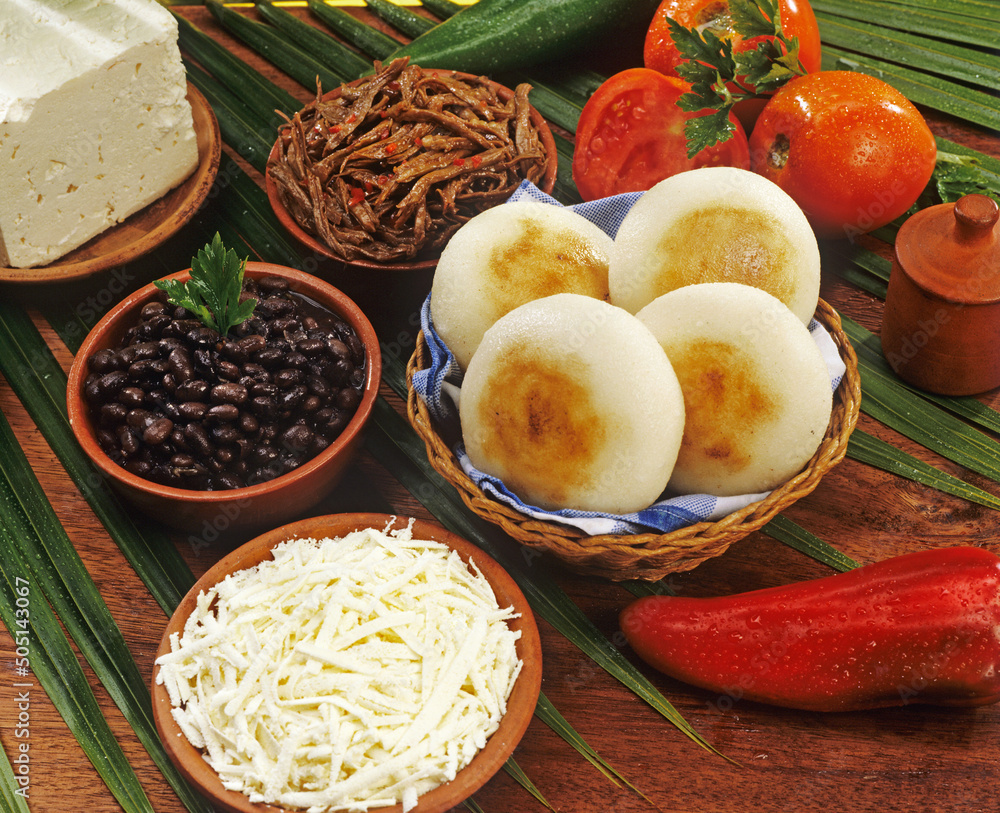 Pabellon criollo and arepas on typical Venezuelan food kitchen table ...