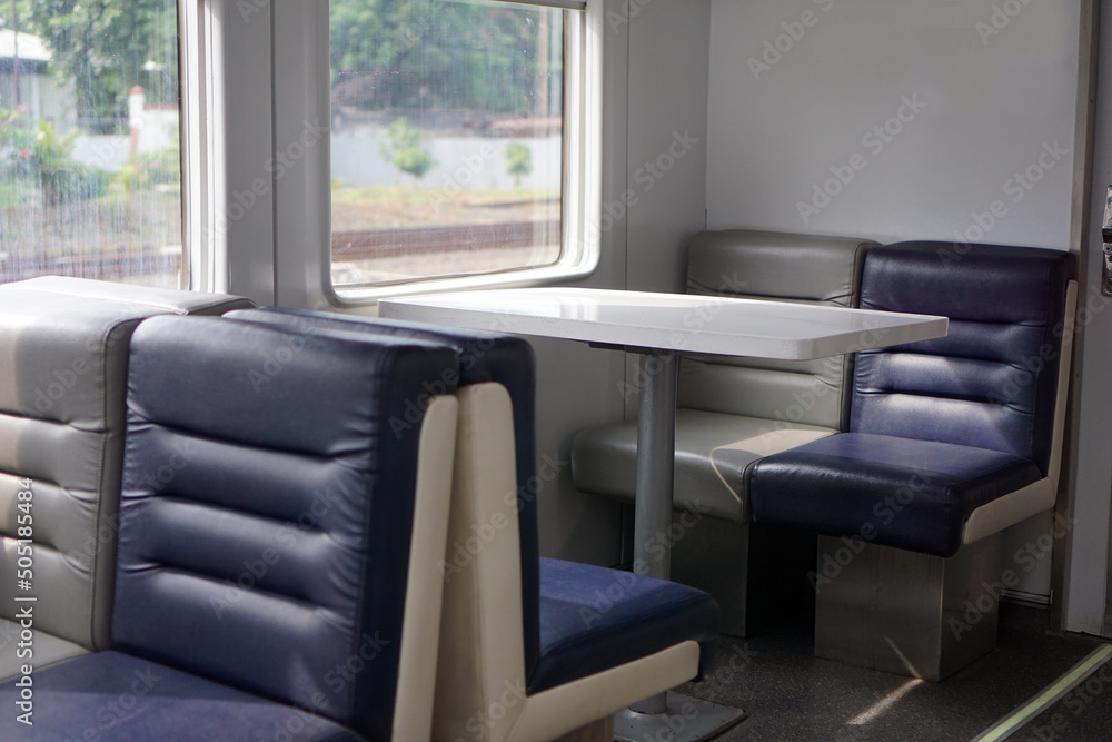 Restaurant chairs and tables in the dining train carriage of an ...
