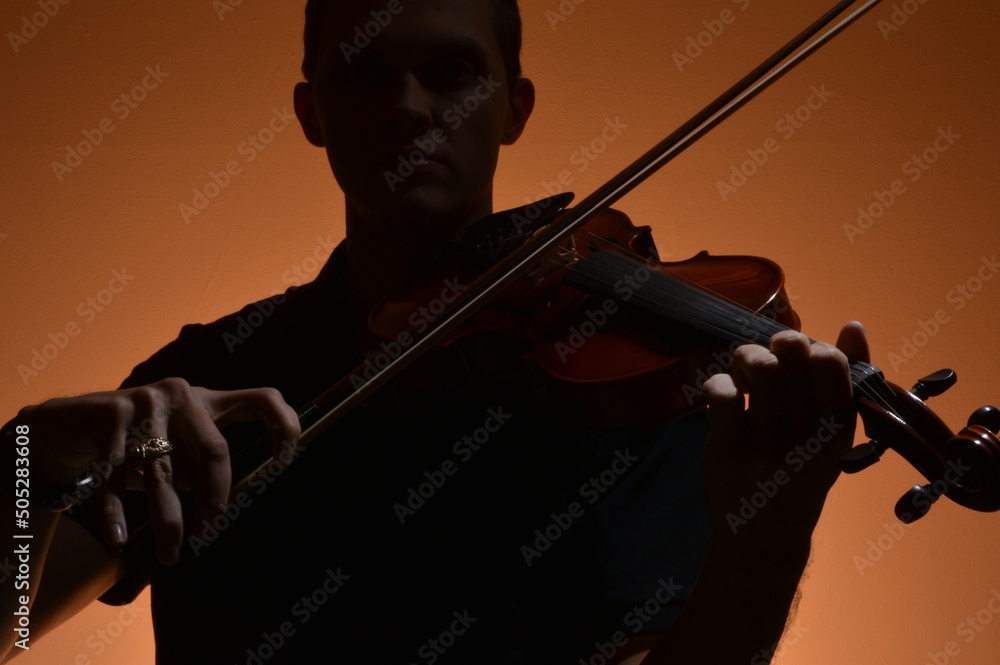 Violin soloist playing his violin Stock Photo | Adobe Stock