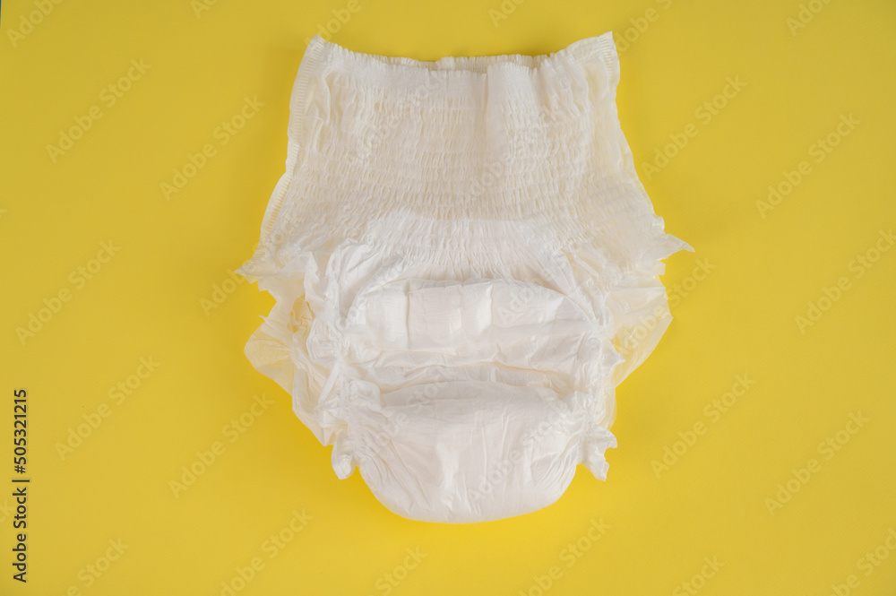 Adult diaper on a yellow background. Incontinence problems. Stock Photo ...