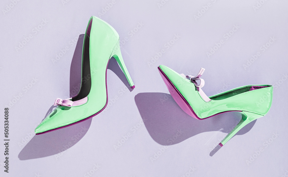 Pare of light green high heel shoes with shadow on purple background ...