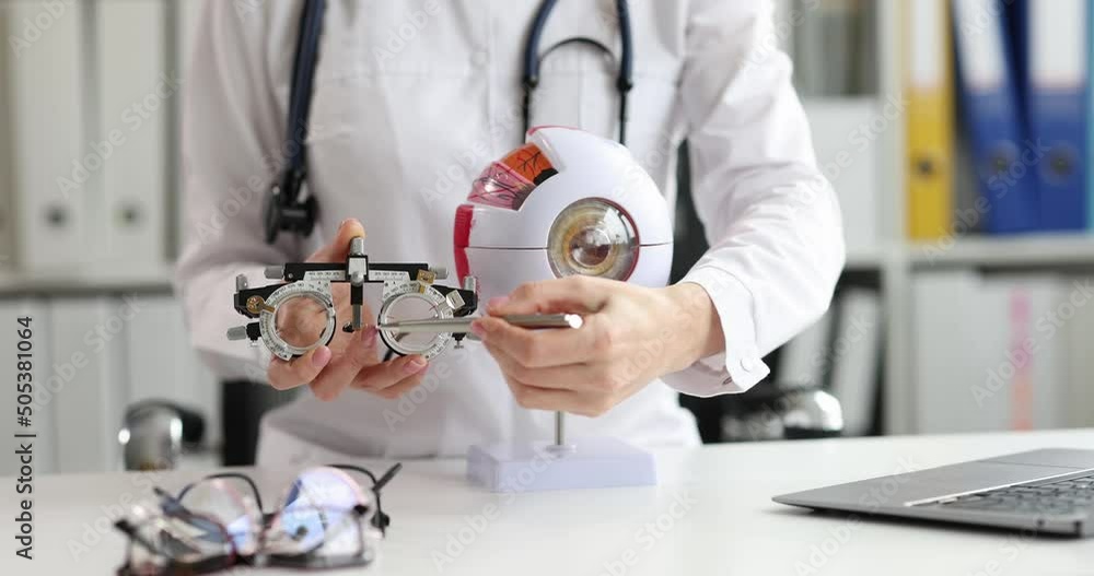 Doctor showing glasses for checking vision and artificial model of ...