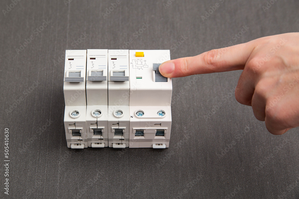 A person turns off an automatic electrical switch to disconnect the ...