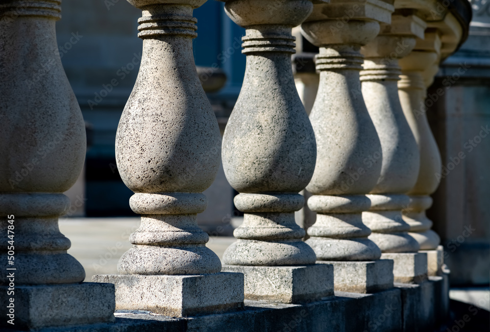 Railing of natural stone or rock supported by balusters forming an ...